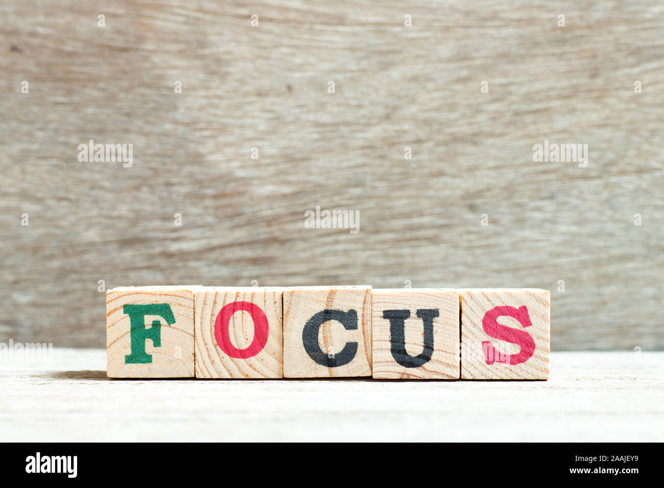 Letter block in word focus on wood background Stock Photo - Alamy