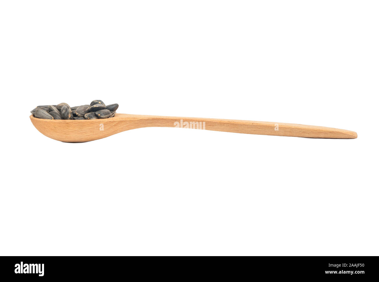 Sunflower seeds in a small wooden spoon on a white background Stock ...