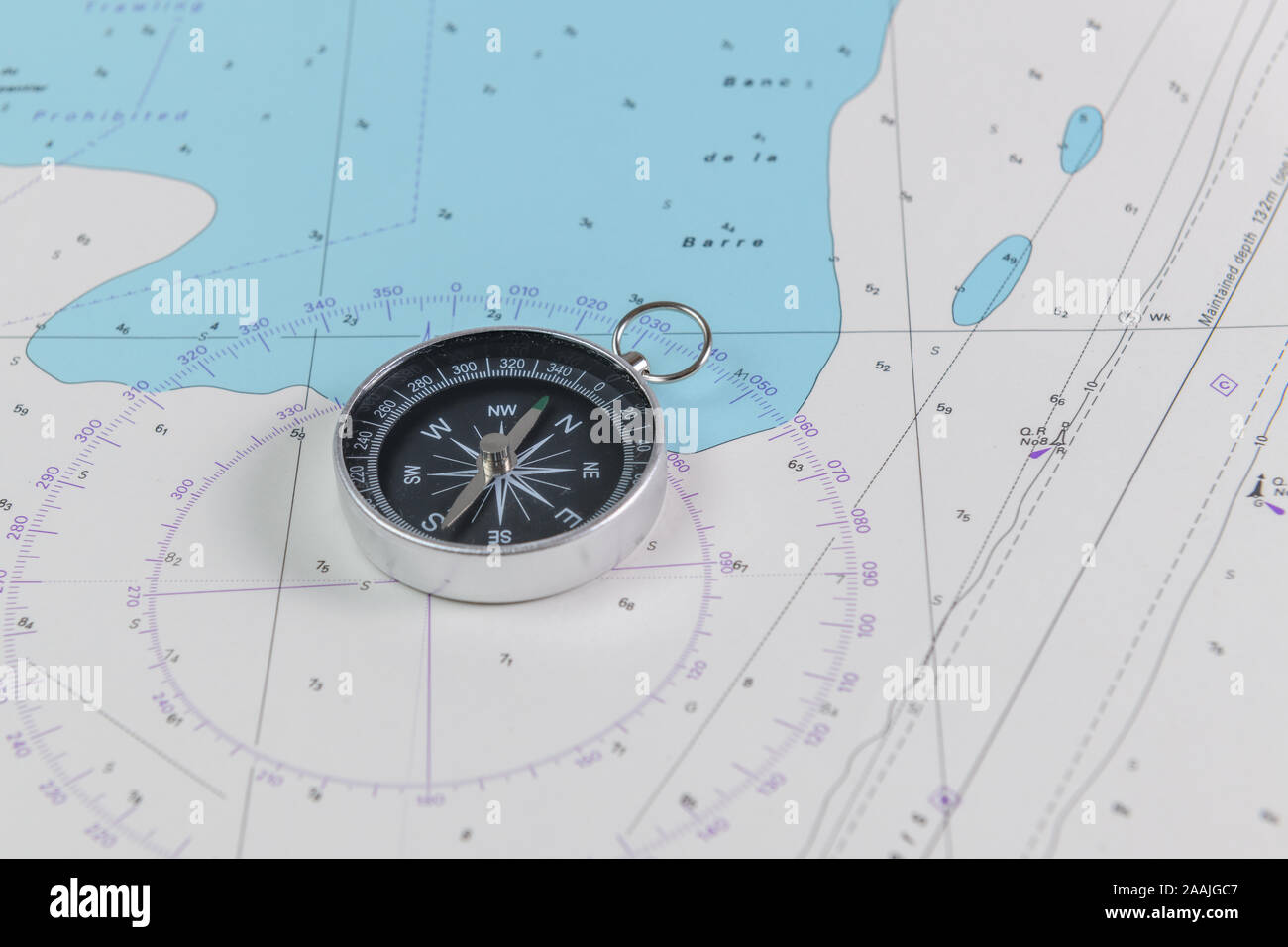 Magnetic compass on a nautical navigational map Stock Photo - Alamy