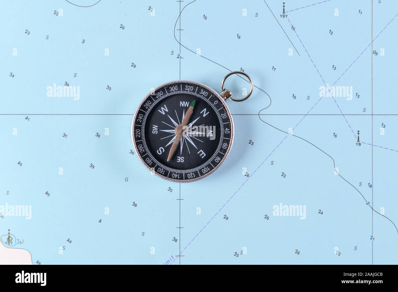 Magnetic compass on a nautical navigational map Stock Photo - Alamy
