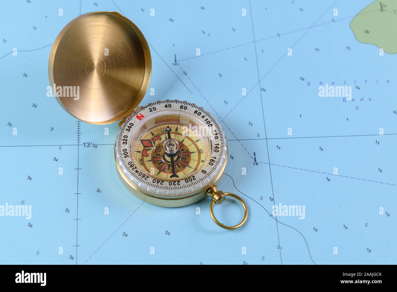 Magnetic compass on a nautical navigational map Stock Photo - Alamy