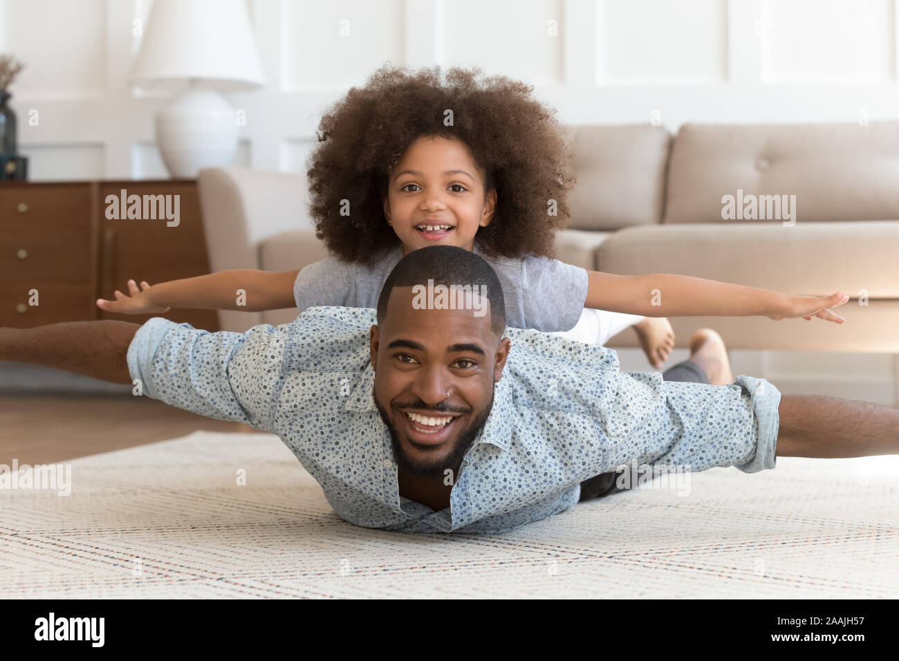 Happy biracial dad and daughter play together at home Stock Photo - Alamy