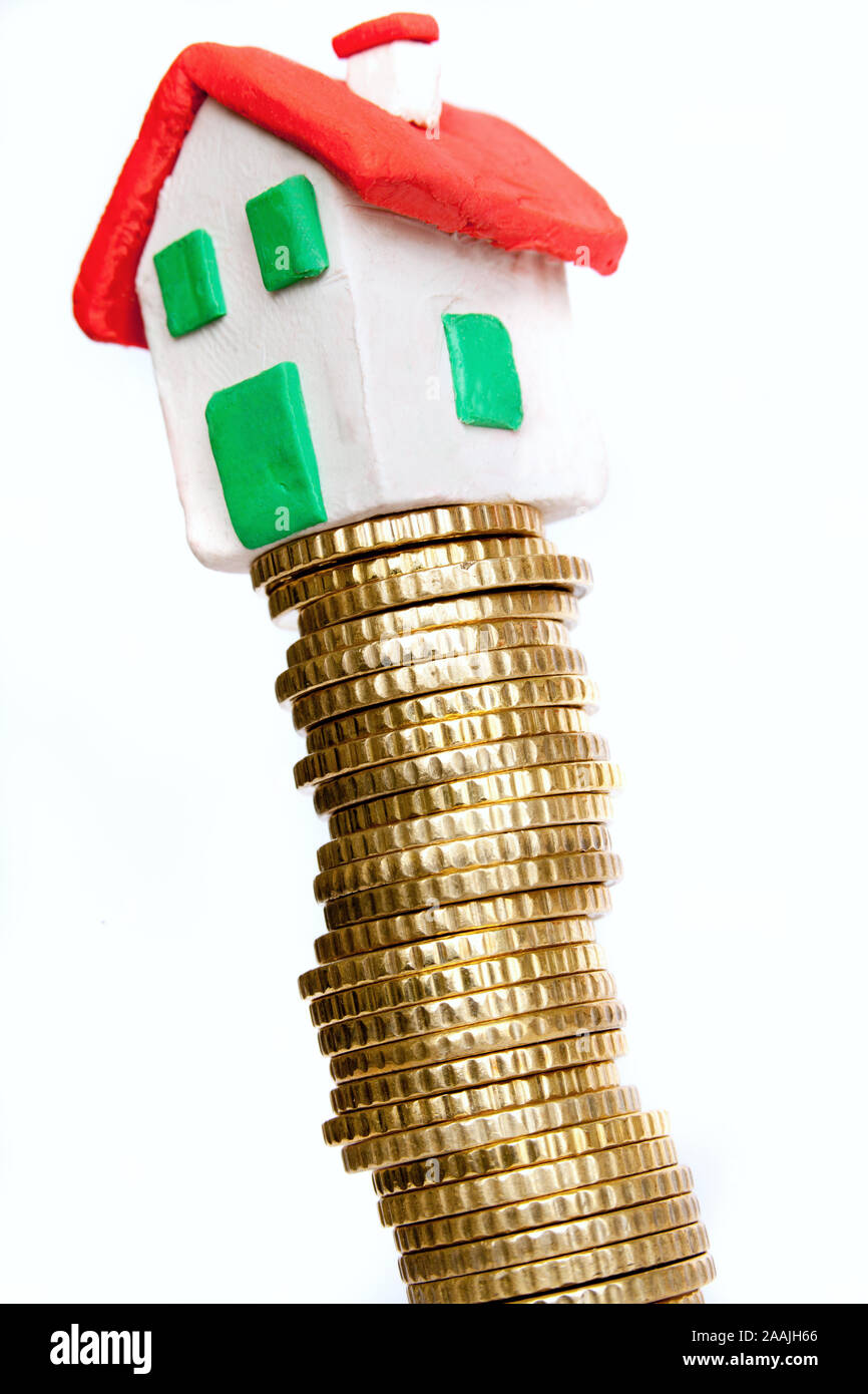 tower of coins with house Stock Photo - Alamy