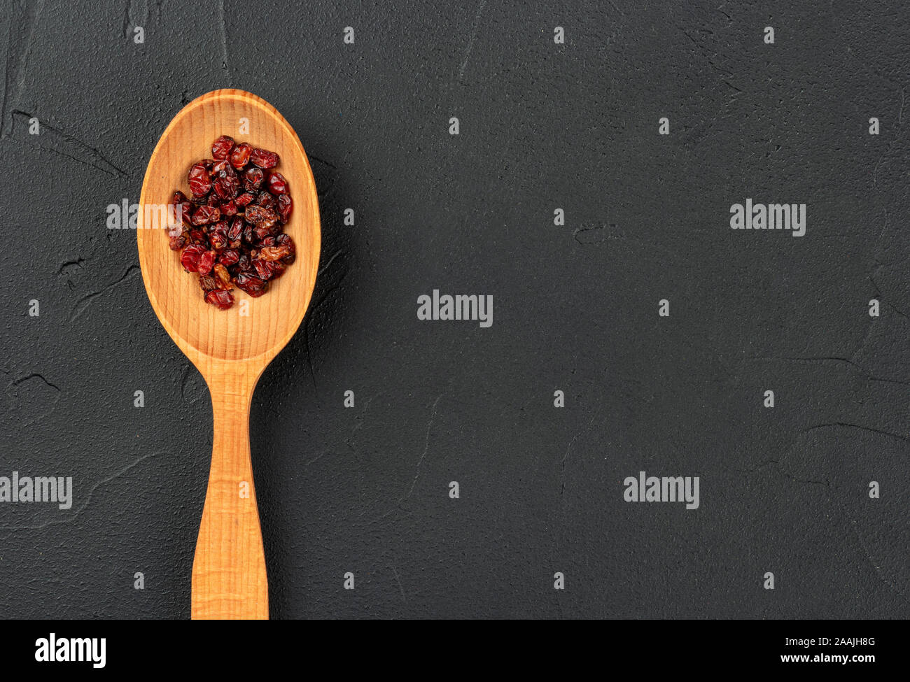 Dry barberry in a wooden spoon on an empty dark background Stock Photo ...