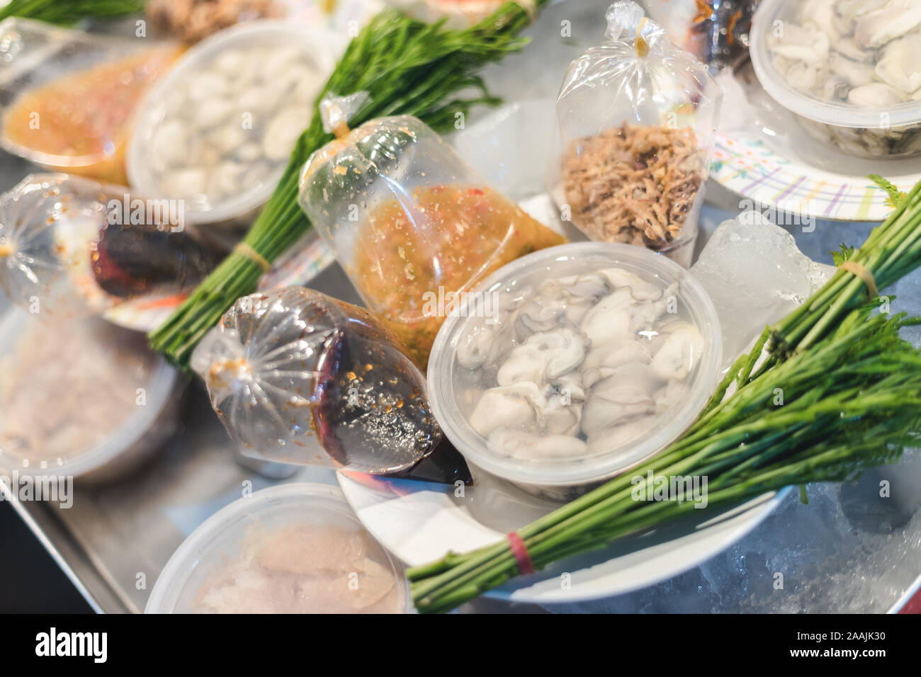 Oyster packing in plastic box selling in a set with sauce and side dish ...