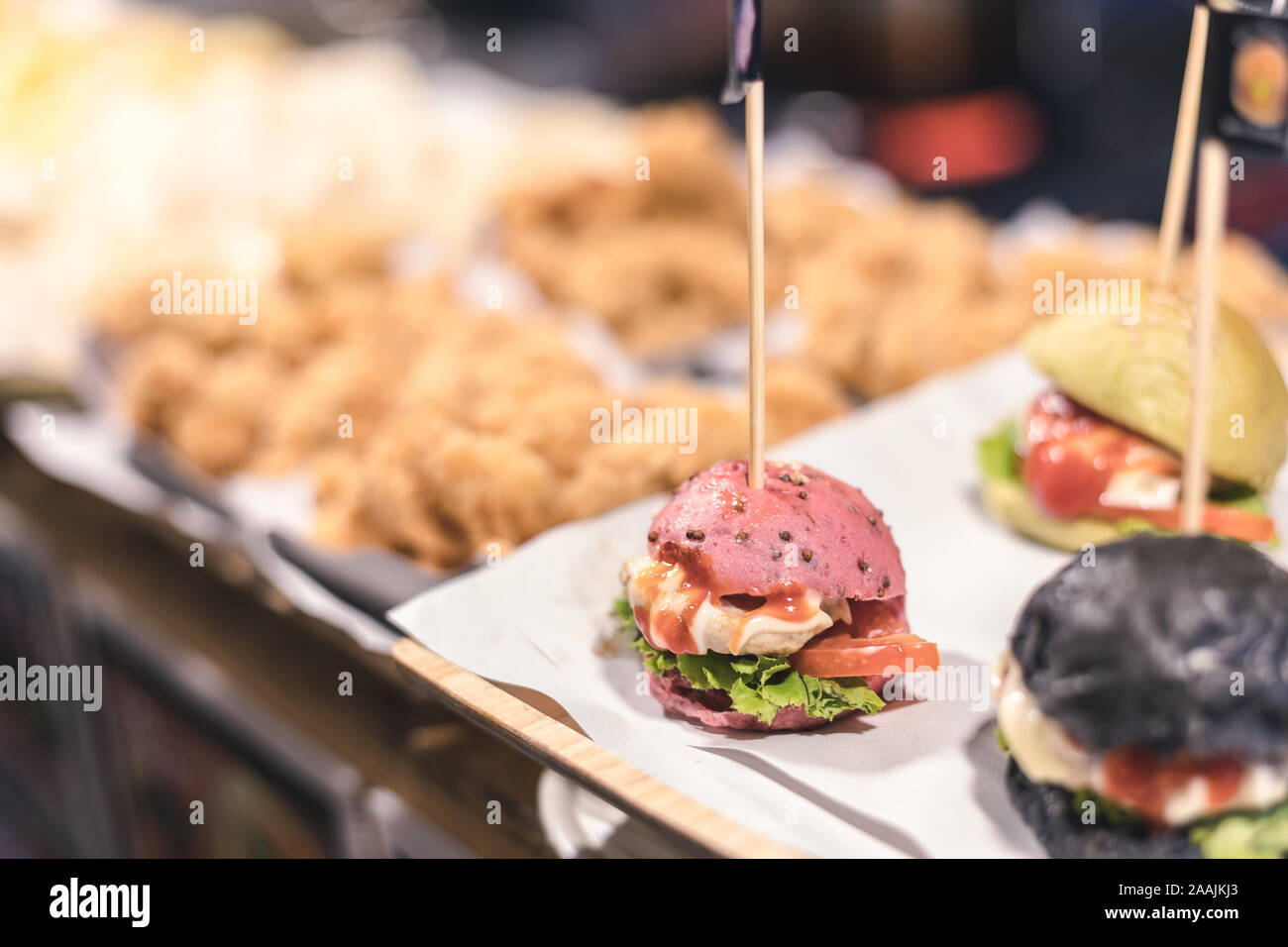 mini pink burger with other color stick with flag stick on top Stock ...