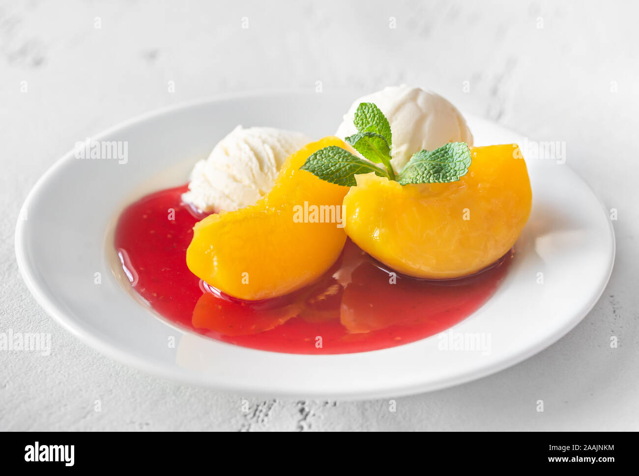 Peach Melba - dessert of peaches and raspberry sauce with vanilla ice ...