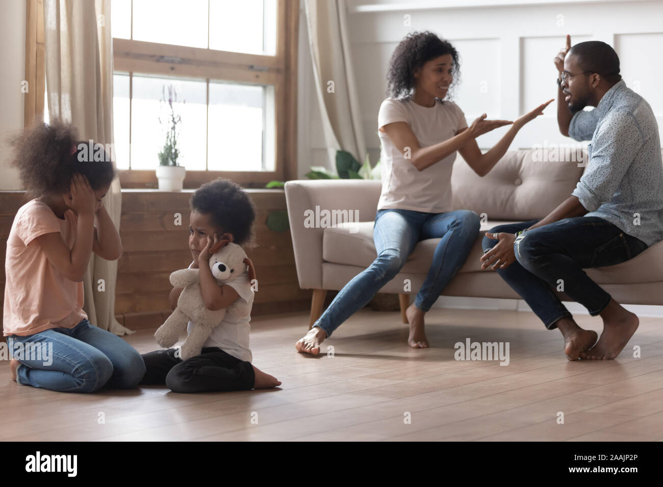 Kids closed ears not to hear how parents quarrelling Stock Photo - Alamy