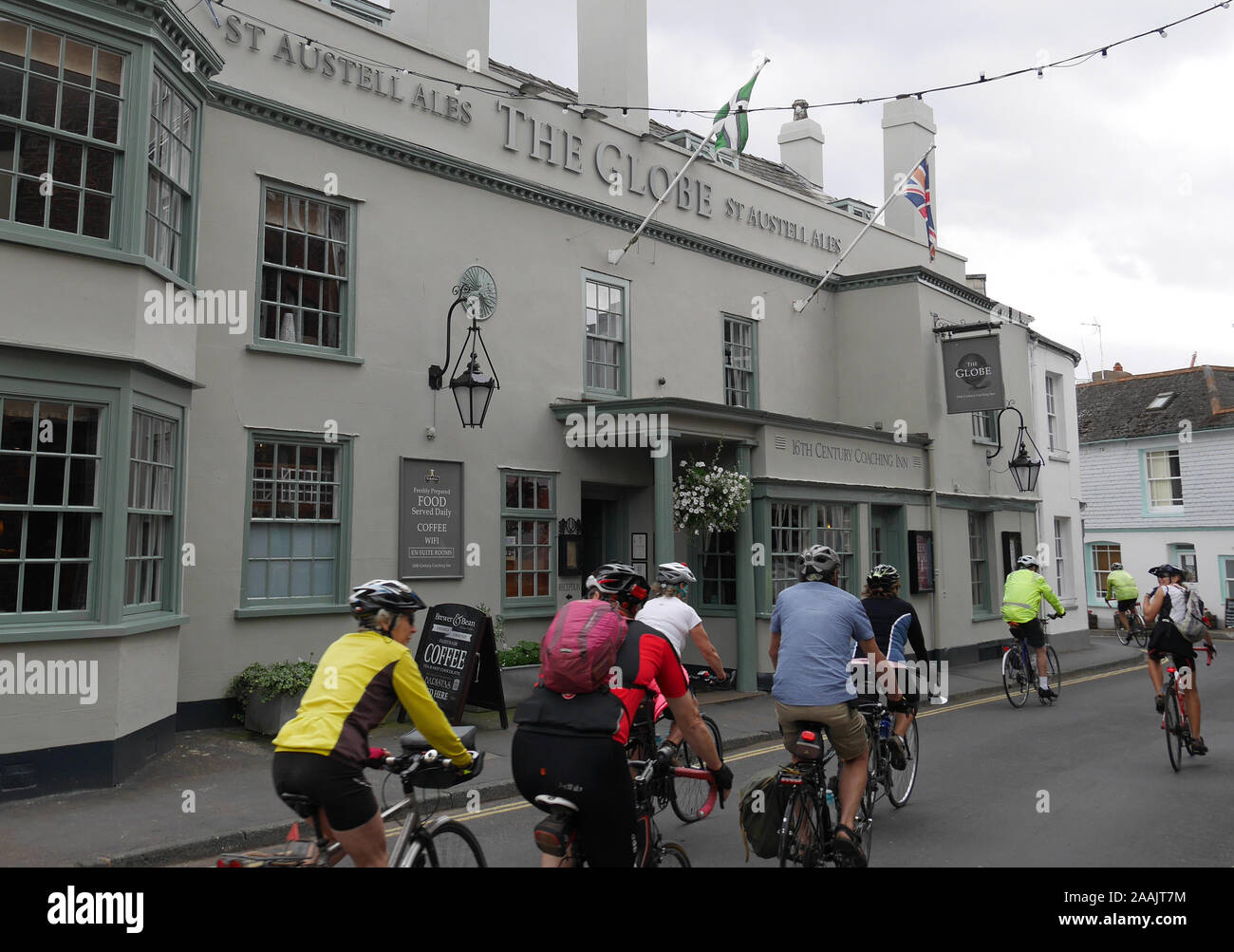 Cyclists wearing colourful outfits, Cycling though the quaint historic ...