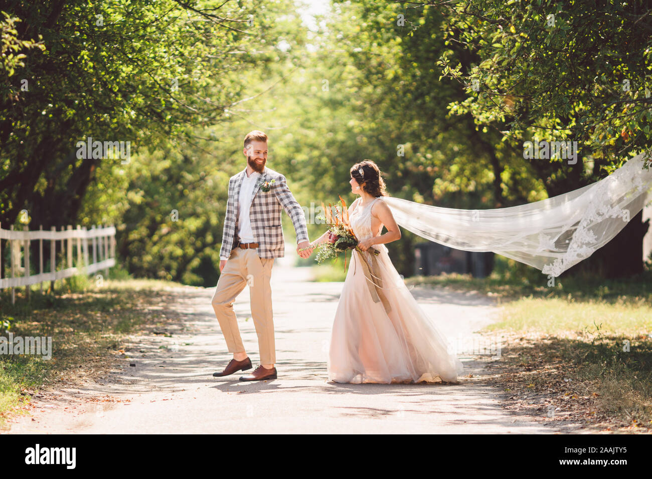 Lovely wedding couple wood forest. Bride and groom, follow me, married ...