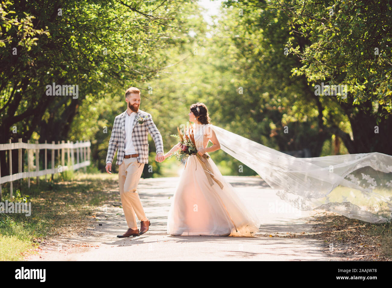 Lovely wedding couple wood forest. Bride and groom, follow me, married ...