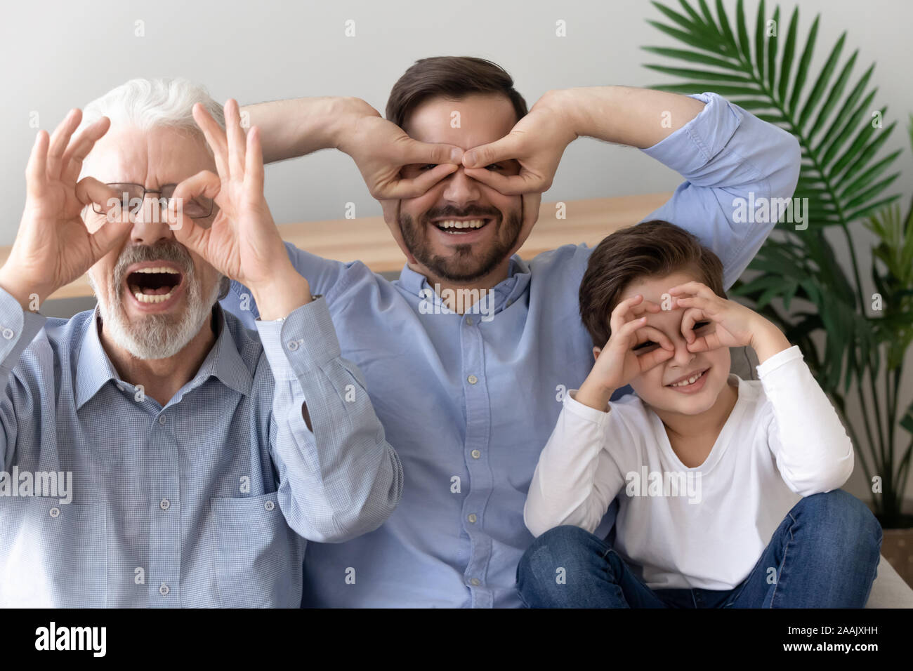 Funny head shot portrait grandfather, father and son, three generations ...