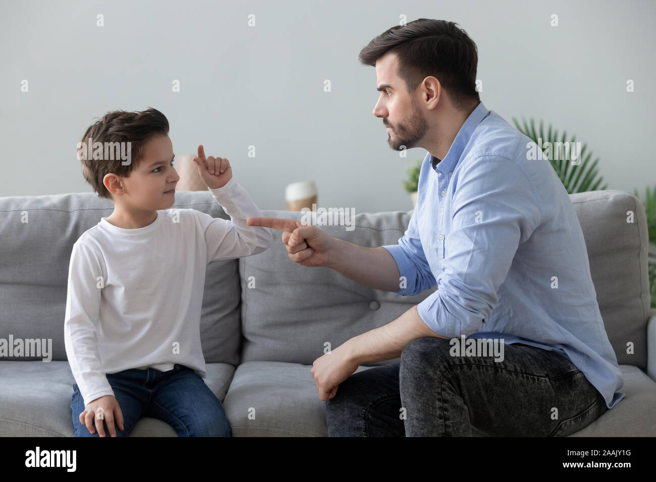 Angry strict father scolding lecturing naughty stubborn little son ...