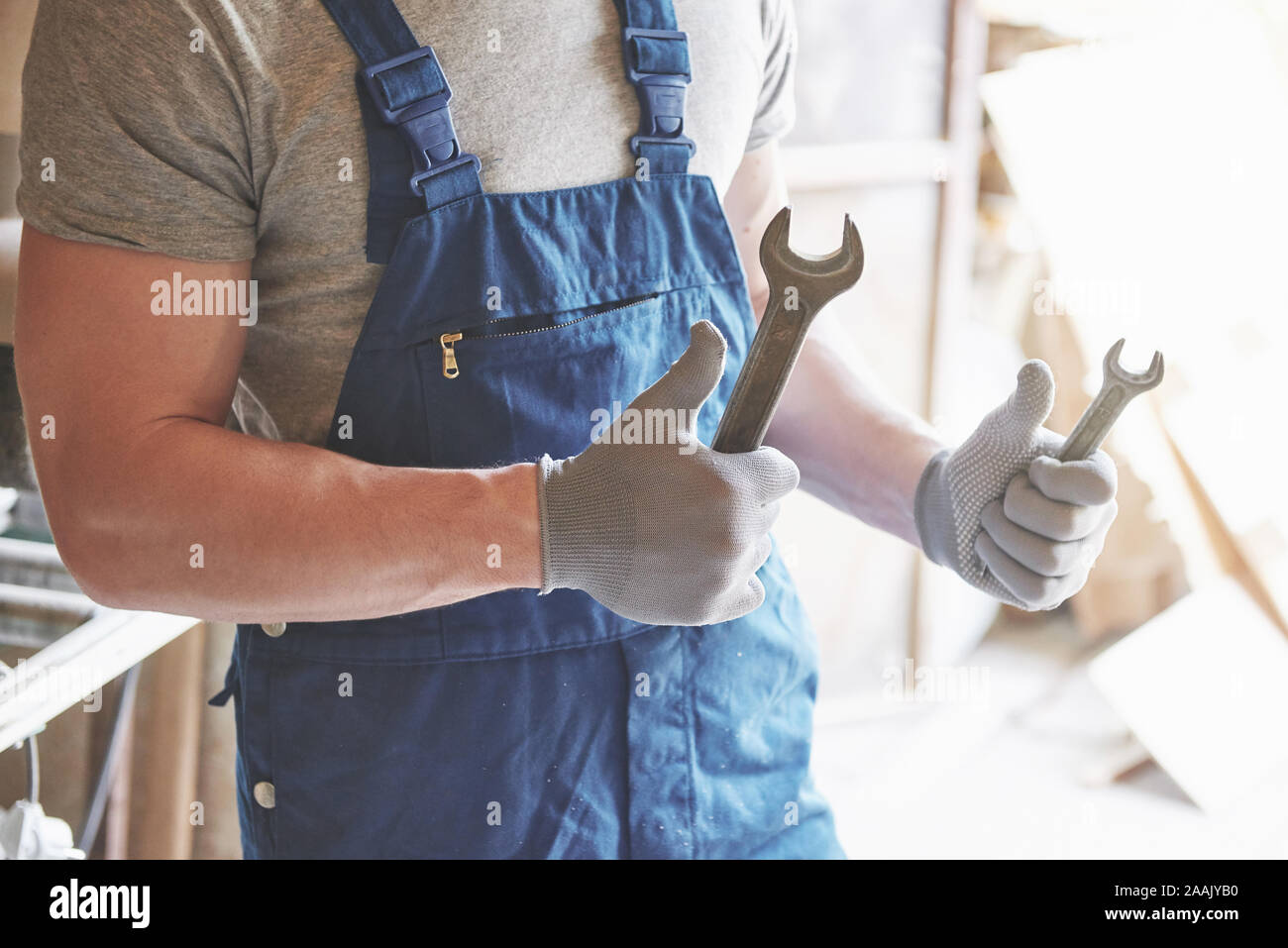 Master in working form and gloves with a key in his hands Stock Photo ...
