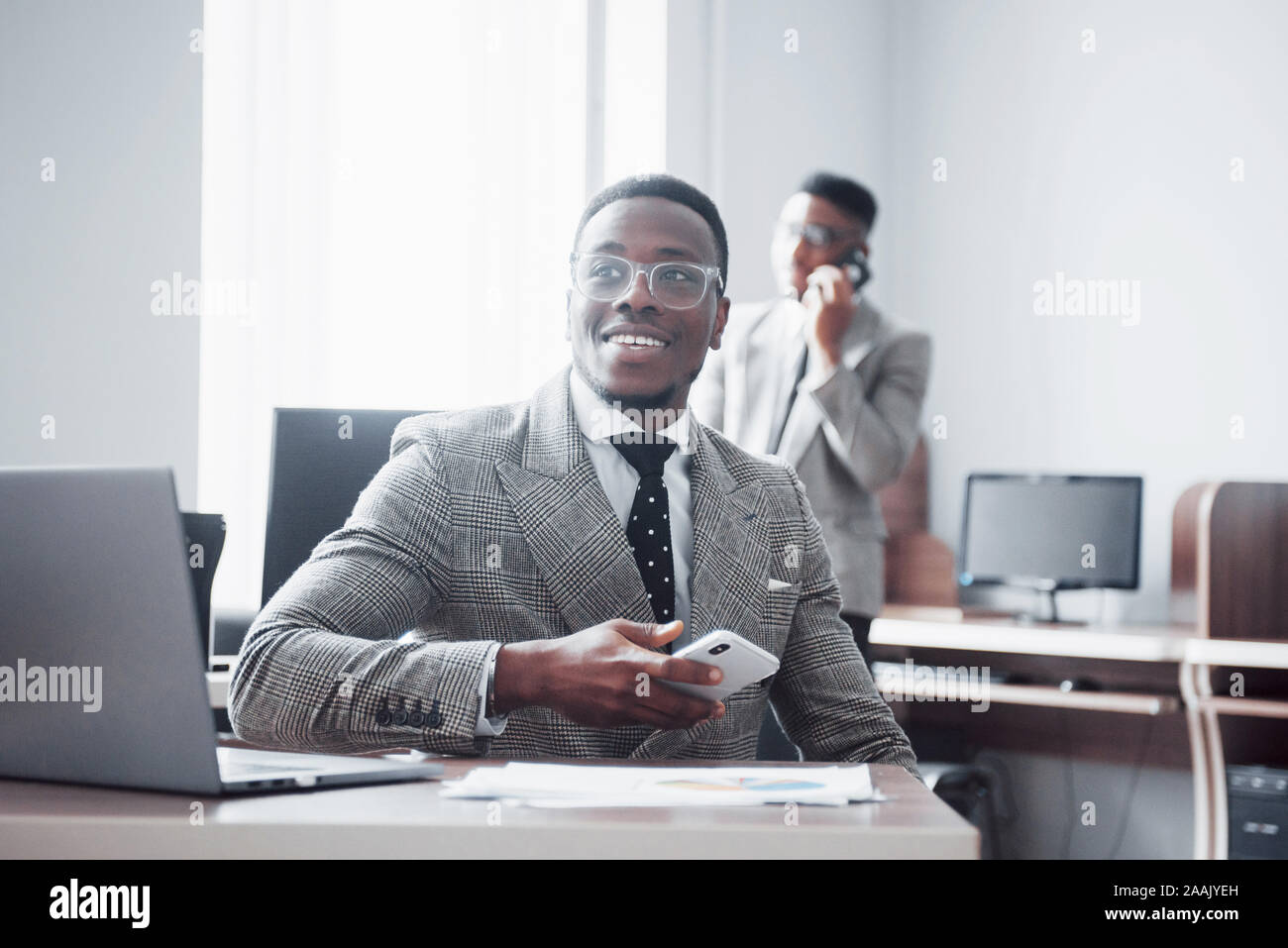 Two handsome cheerful african american executive business man at the ...