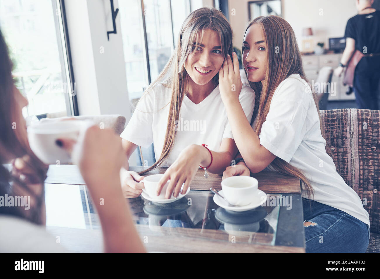 The three best girlfriends gathered to drink coffee and gossip. Girls ...