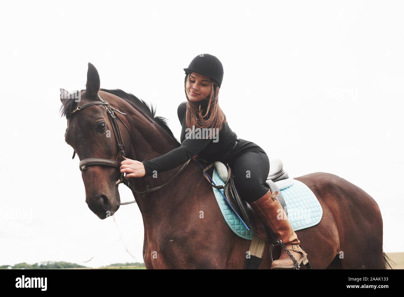 Young pretty girl - riding a horse, equestrian sport in spring time ...