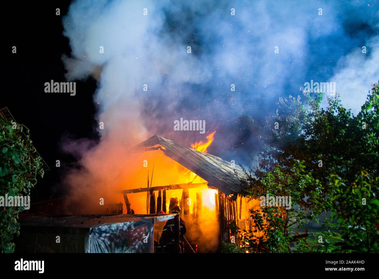 Wooden house or barn burning on fire at night Stock Photo - Alamy