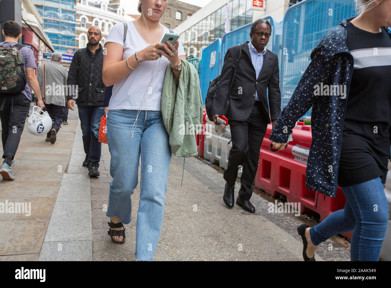 Pedestrians using mobile phones on the streets of London, UK Stock ...