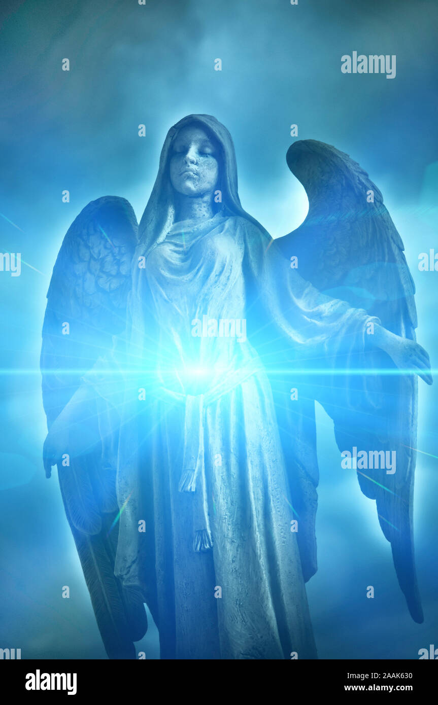angel statue with open arms and divine light Stock Photo - Alamy