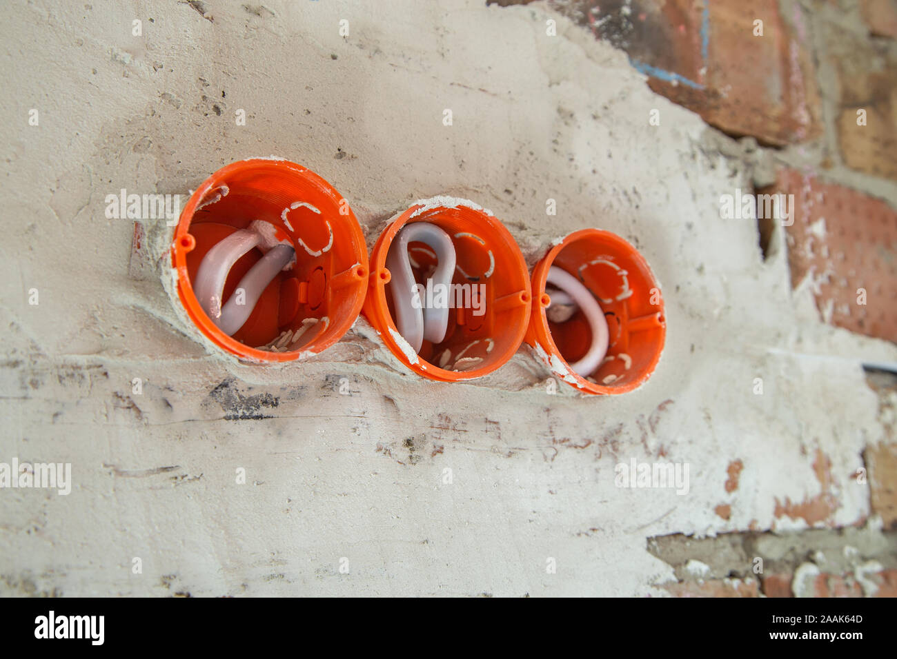 Socket orange boxes with wires in a wall. Cabling installation of ...