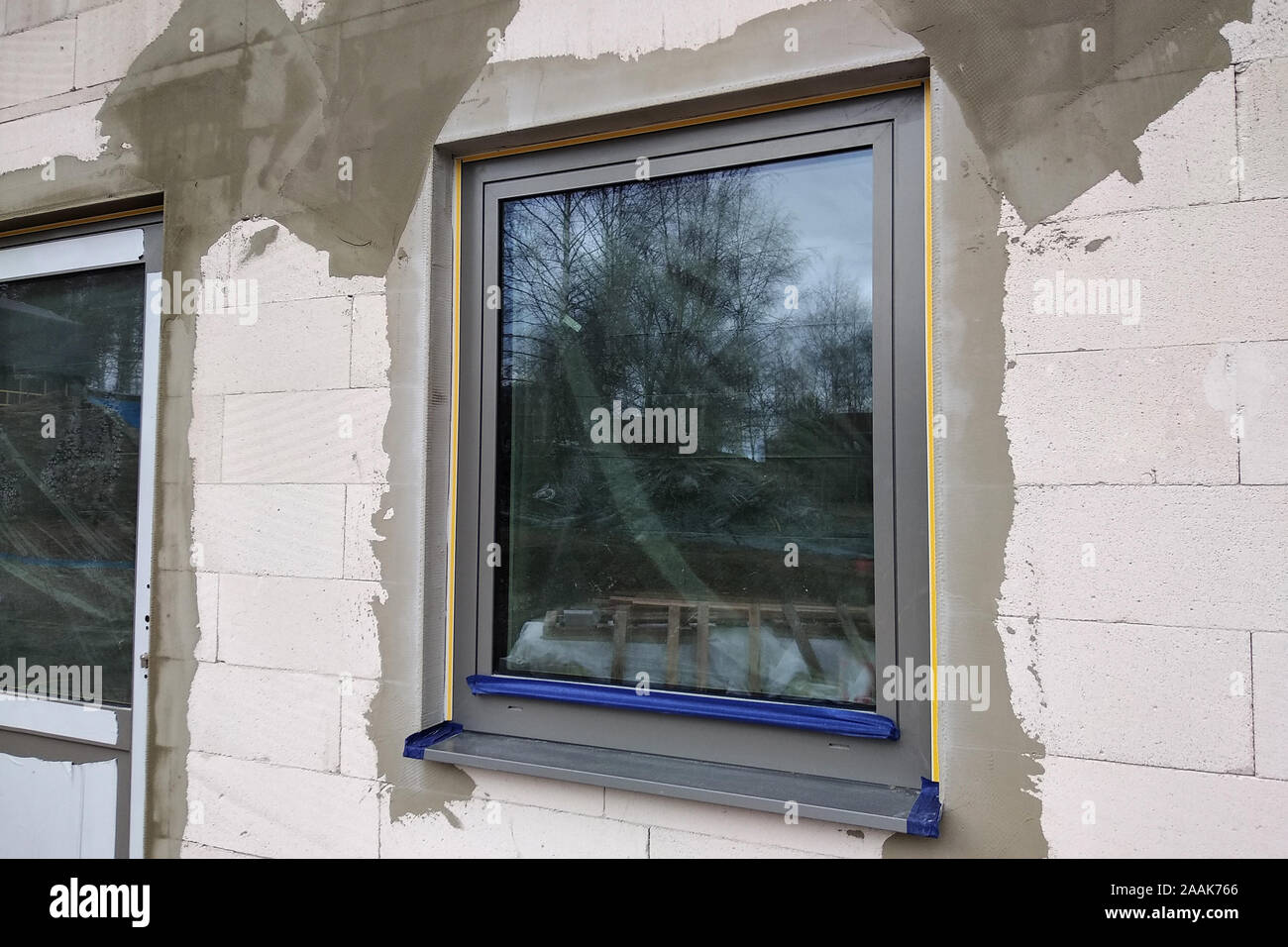 Facade of building made from white blocks with big windows under ...