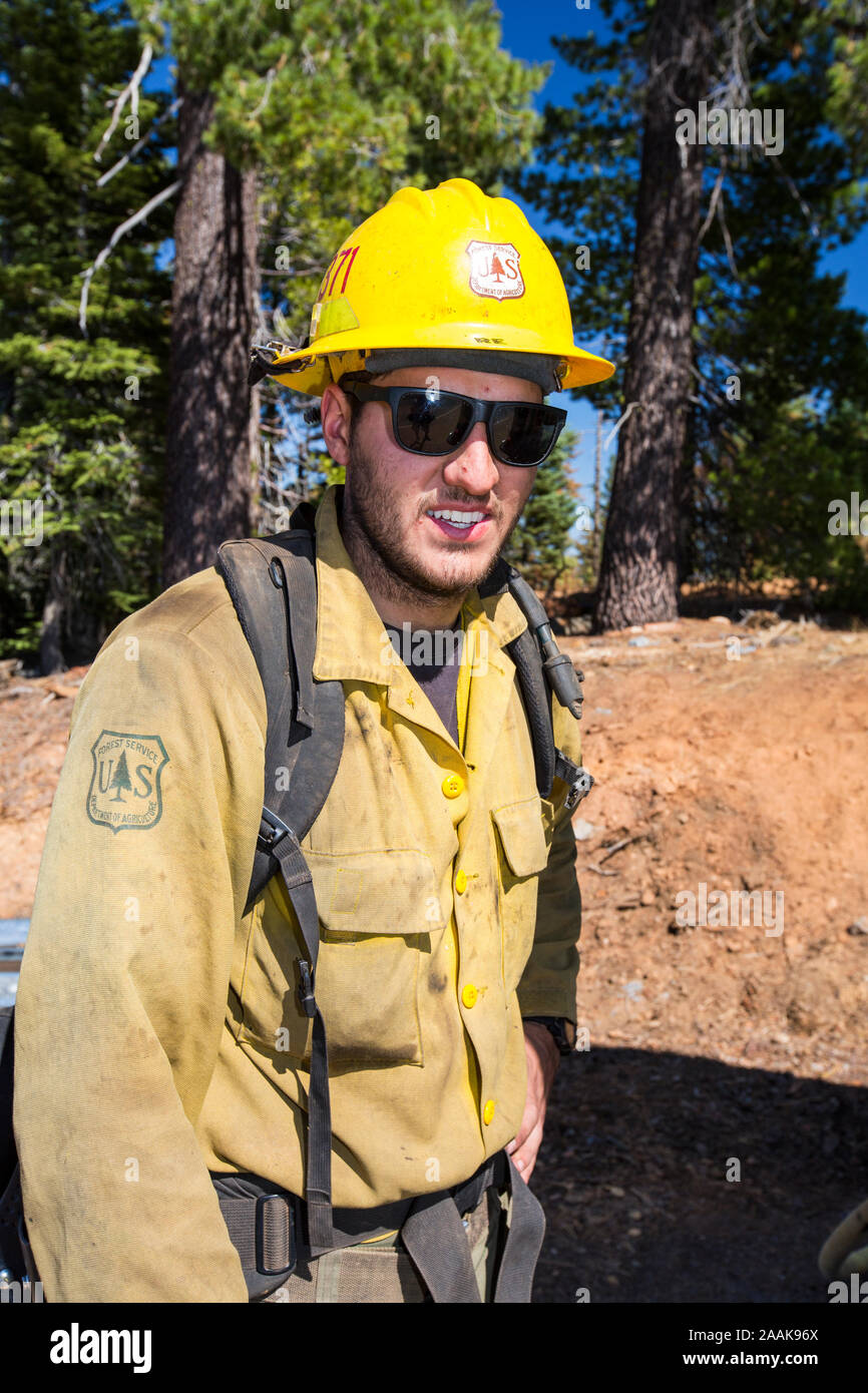 An exhausted fire fighter in the middle of a 14 hour shift, tackling ...