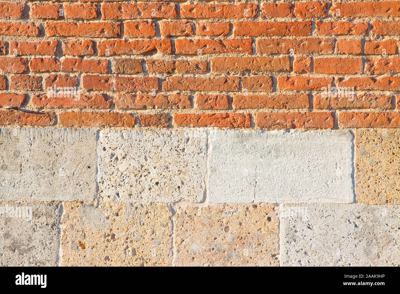 Old italian brick and bright stone wall after an architectural ...