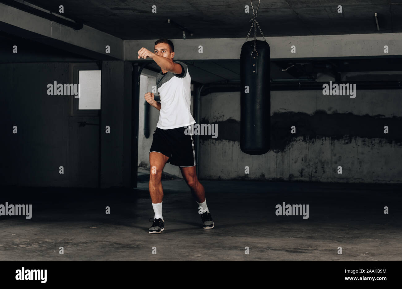 Man throwing a fierce and powerful punch. Photo of muscular man ...