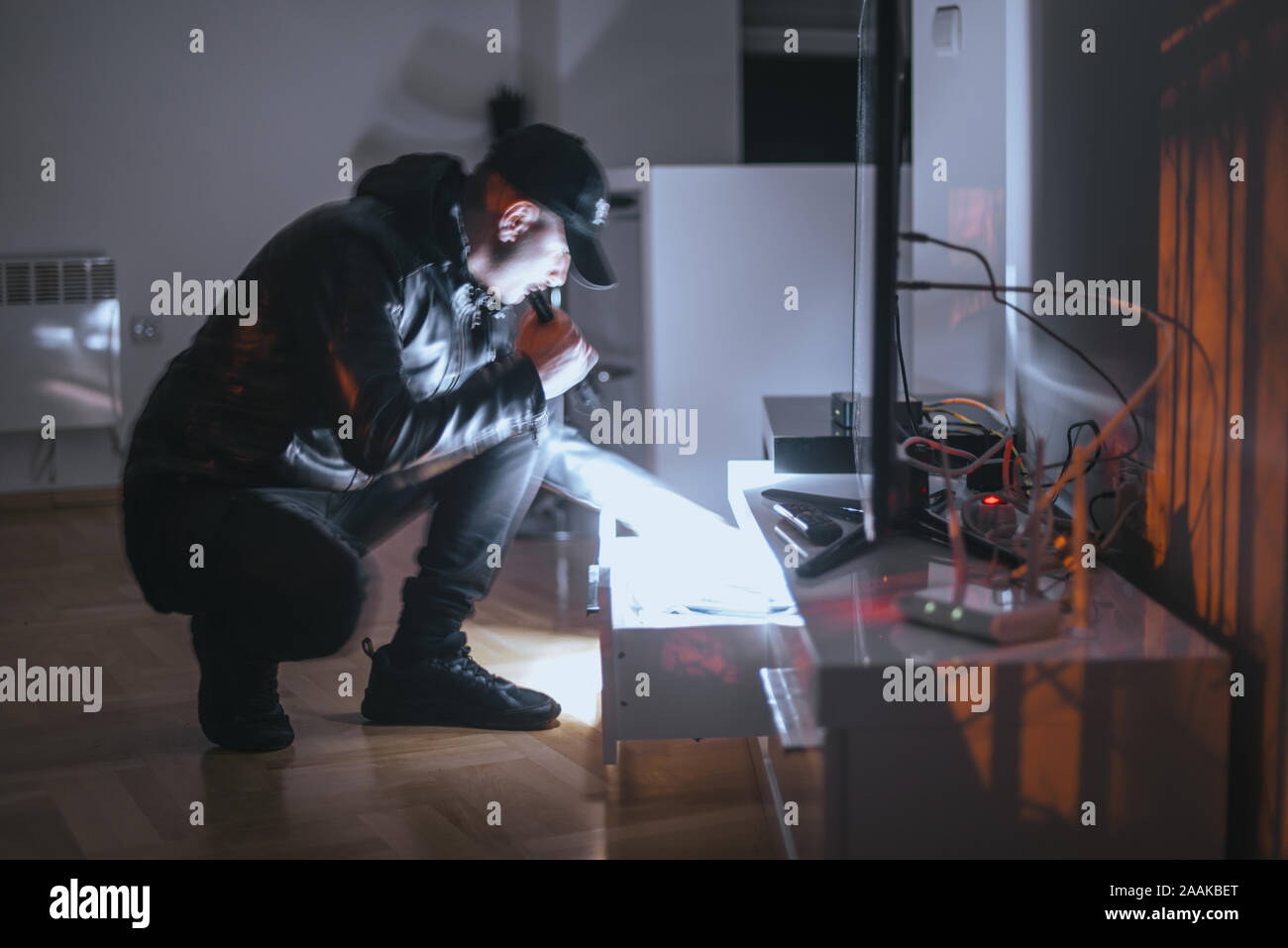 Crime scene with robber with torch in living room while stealing ...