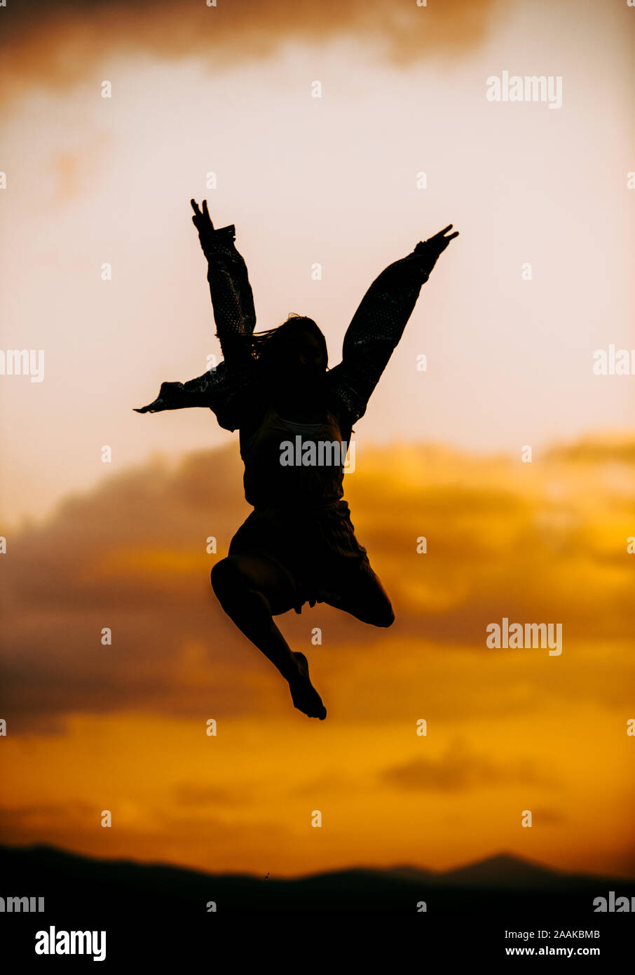 Full of energy young woman dancer in a beautiful dance move Stock Photo ...