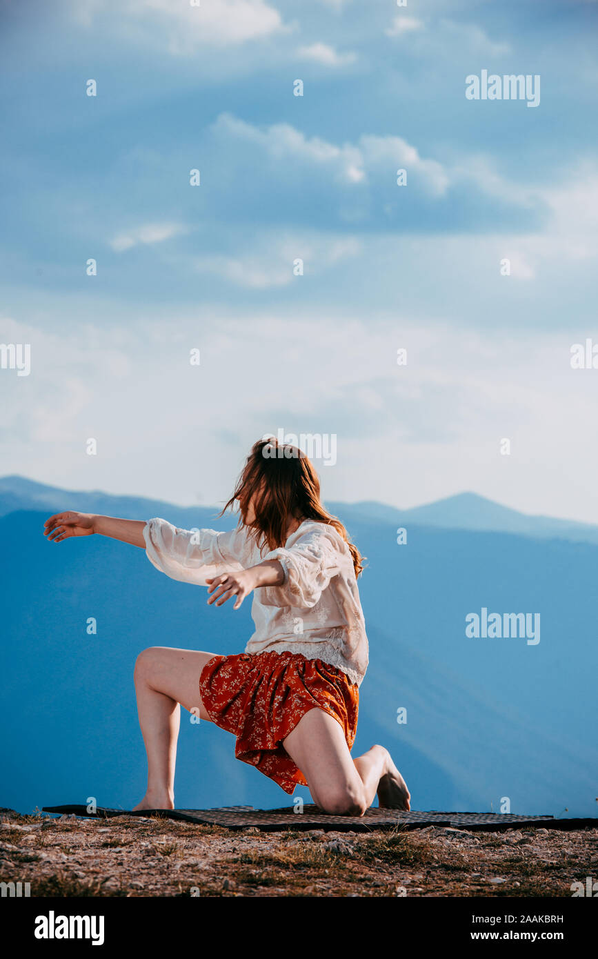 Happy beautiful free woman dancing on the mountain hill, playful having ...