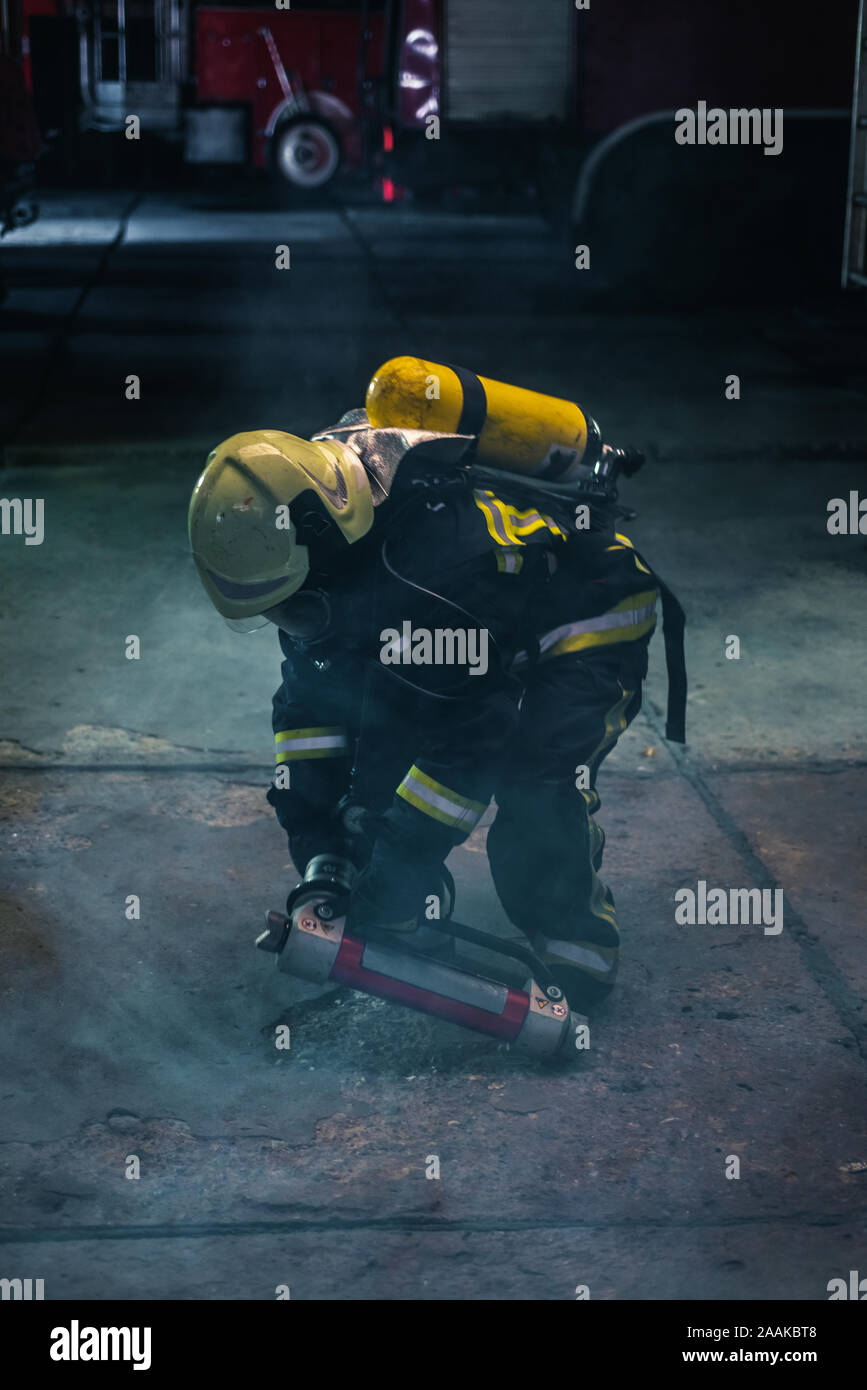 Portrait of a female firefighter wearing a helmet and all safety ...