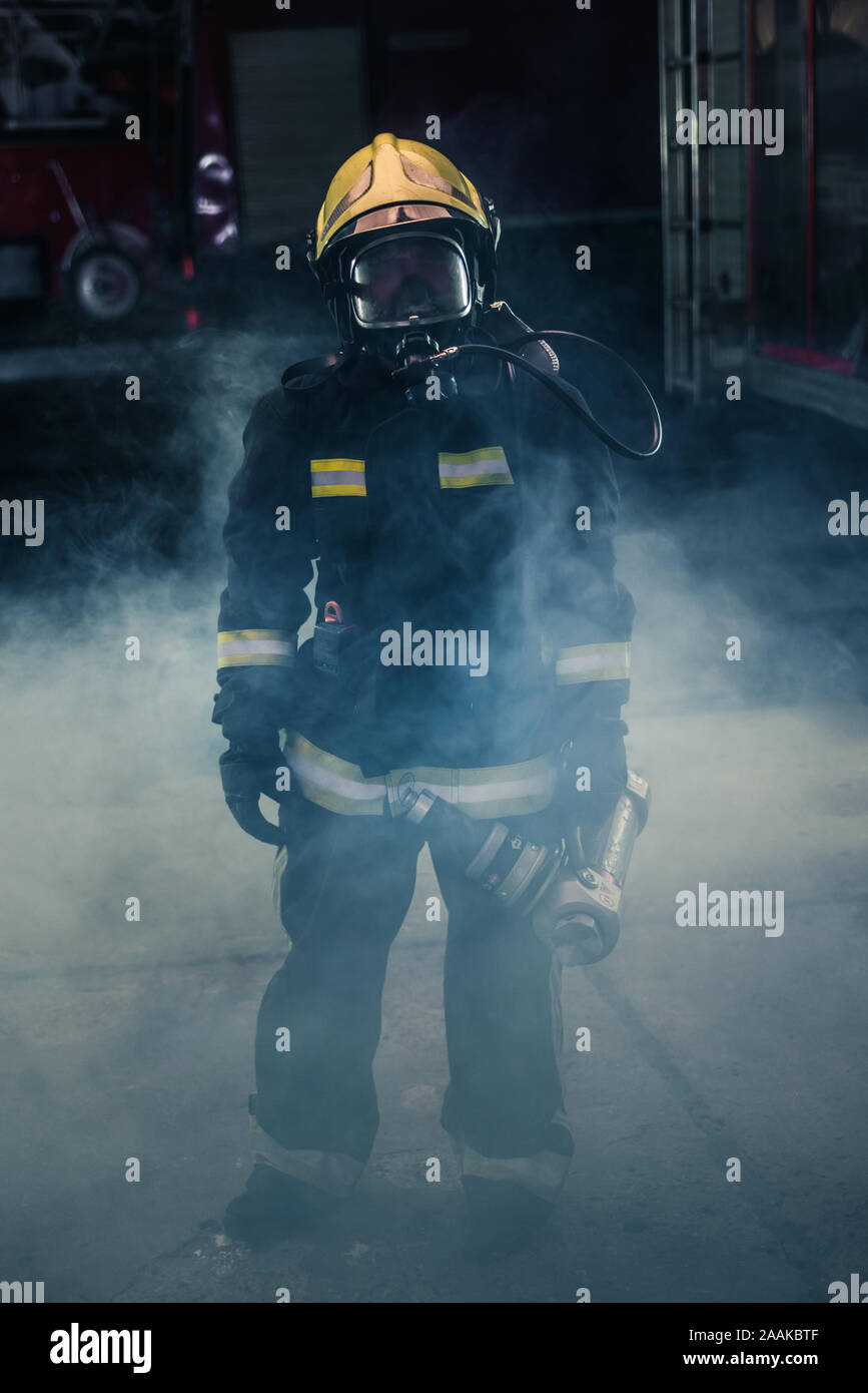 Portrait of a female firefighter wearing a helmet and all safety ...