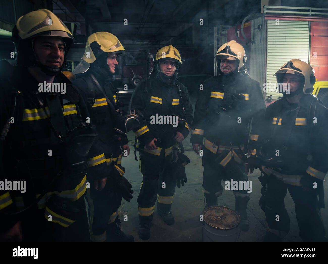 Team of firefighters standing inside ( indoors ) a buliding next to a ...