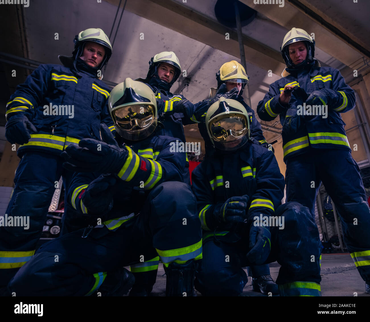 Portrait of group firefighters in front of firetruck inside the fire ...