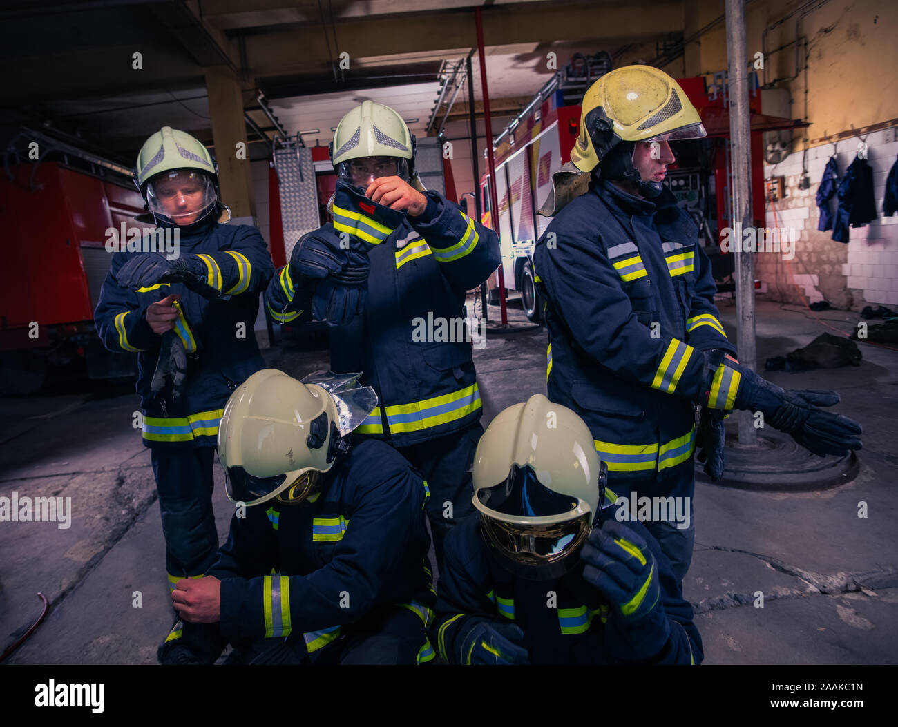Portrait of group firefighters in front of firetruck inside the fire ...