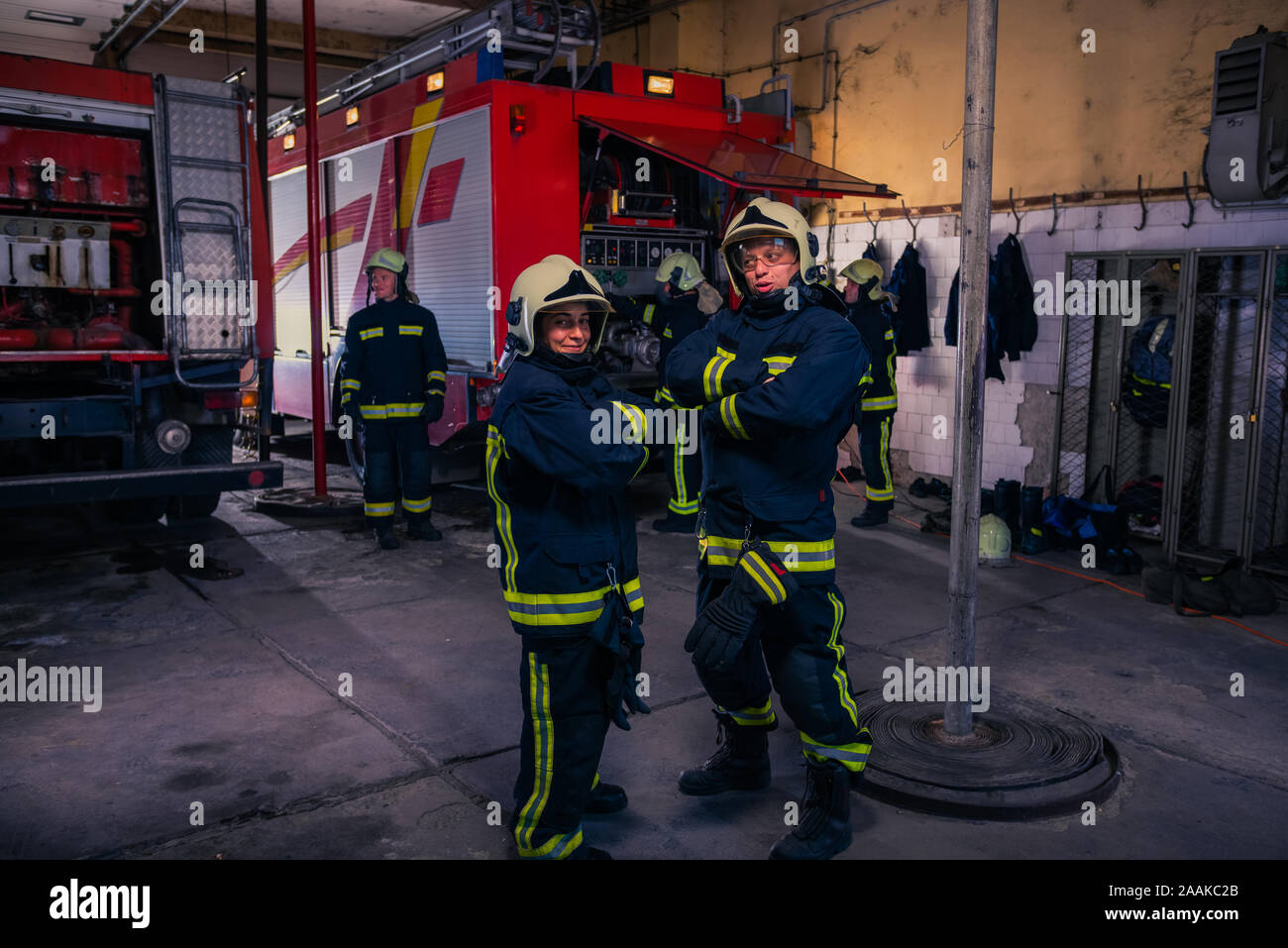 Firefighters preparing their uniform and the firetruck in the ...