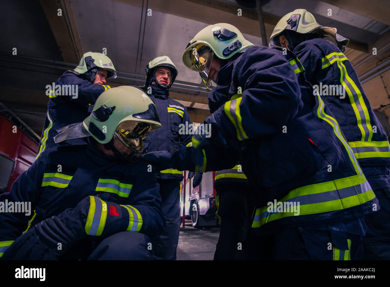 Portrait of group of firefighters wearing protective uniform inside the ...