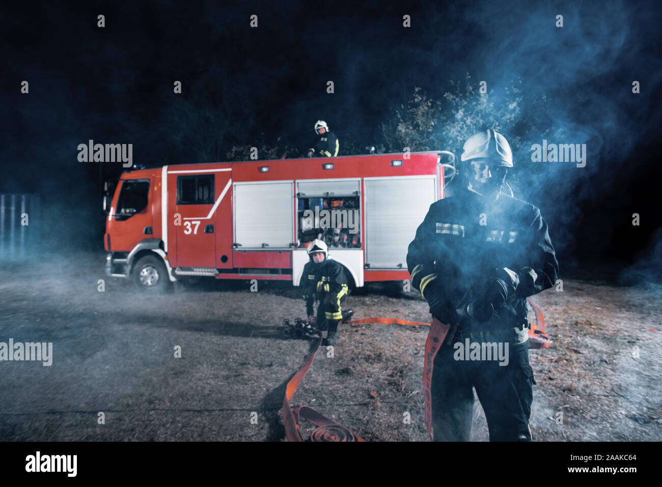 Firefighter operating fire engine hi-res stock photography and images ...
