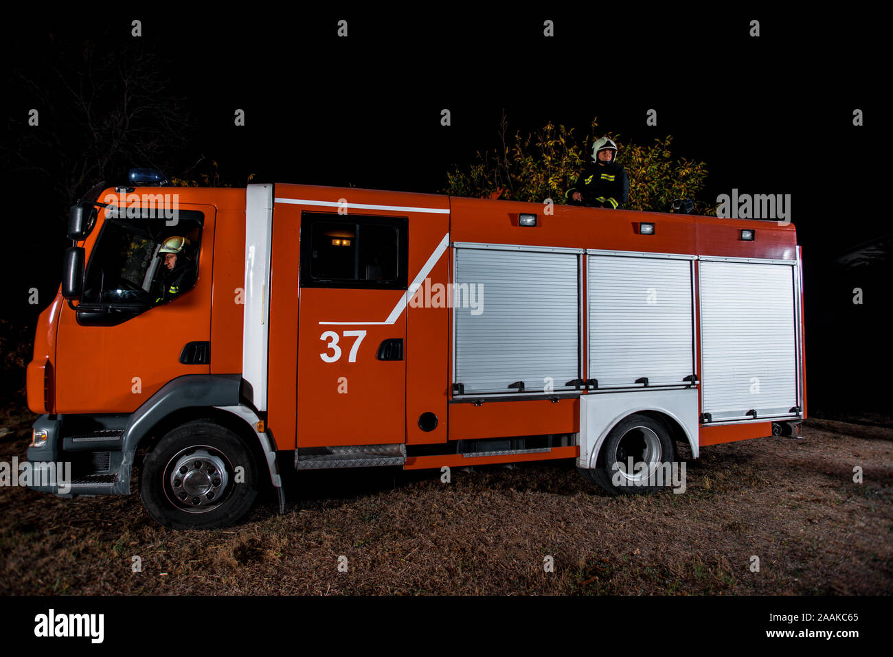 Fire brigade during operation in the field at night time Stock Photo ...