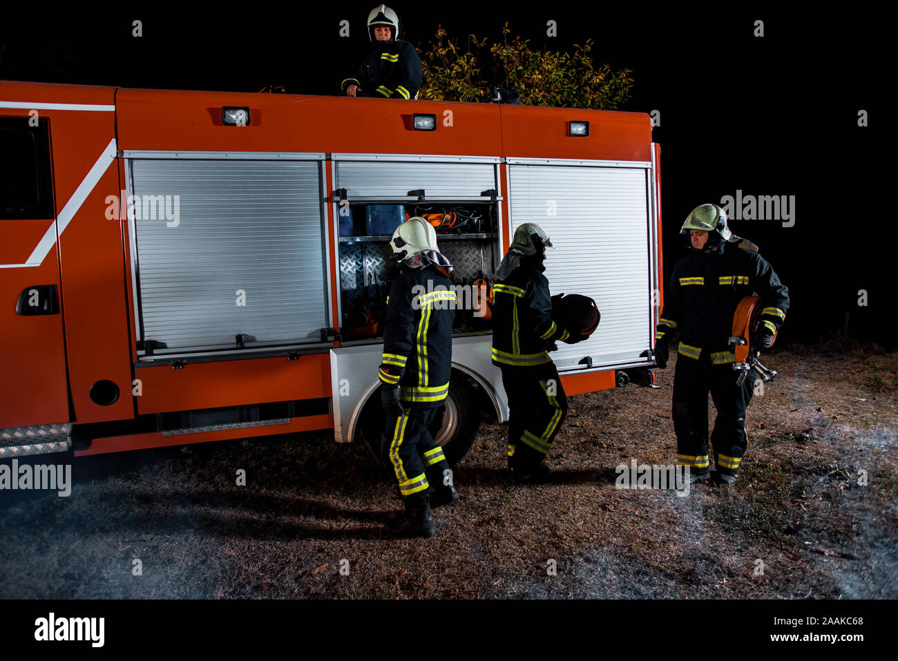Firemen getting ready during a firefighting intervention Stock Photo ...