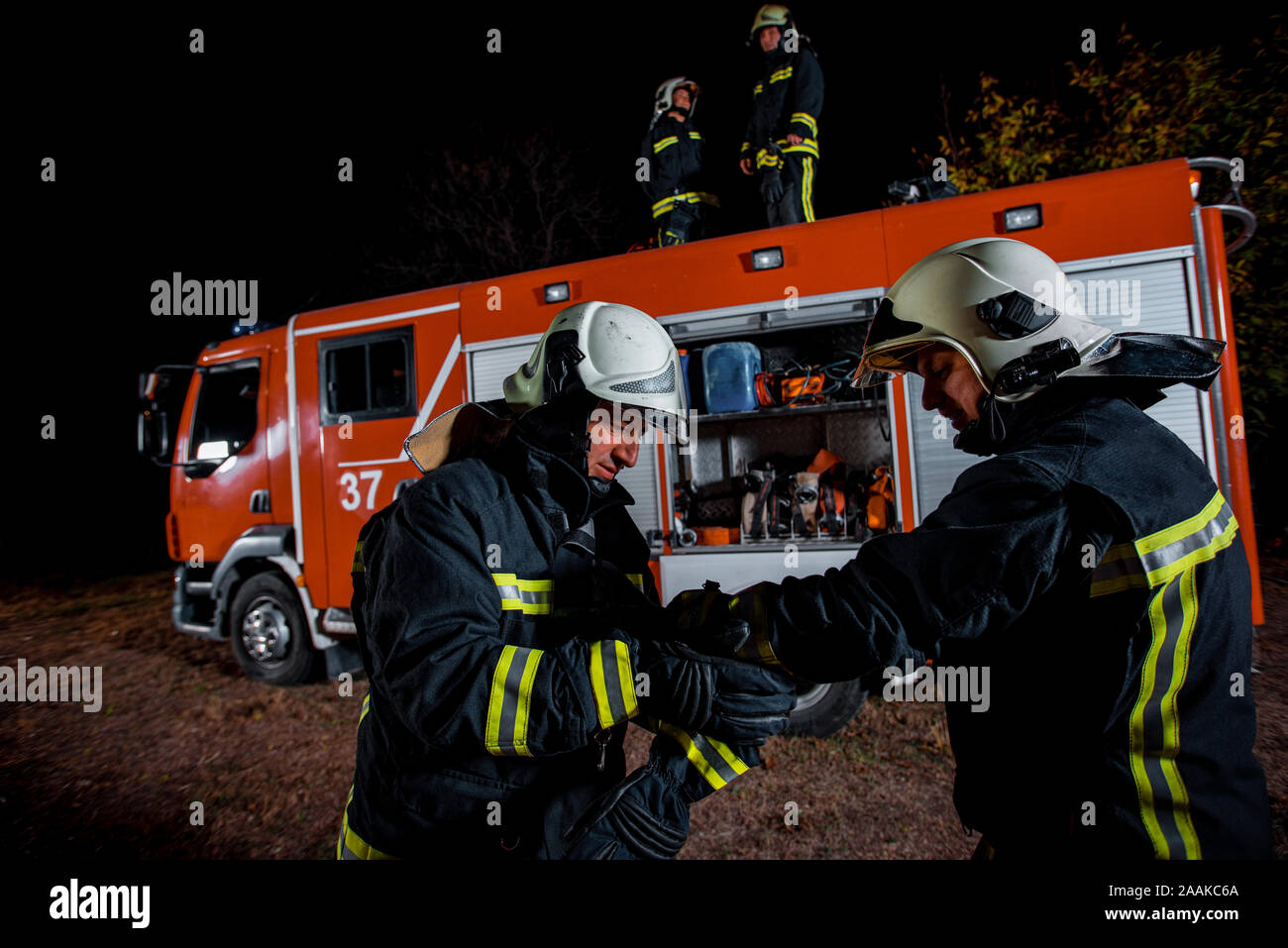 Fire brigade during operation in the field at night time Stock Photo ...