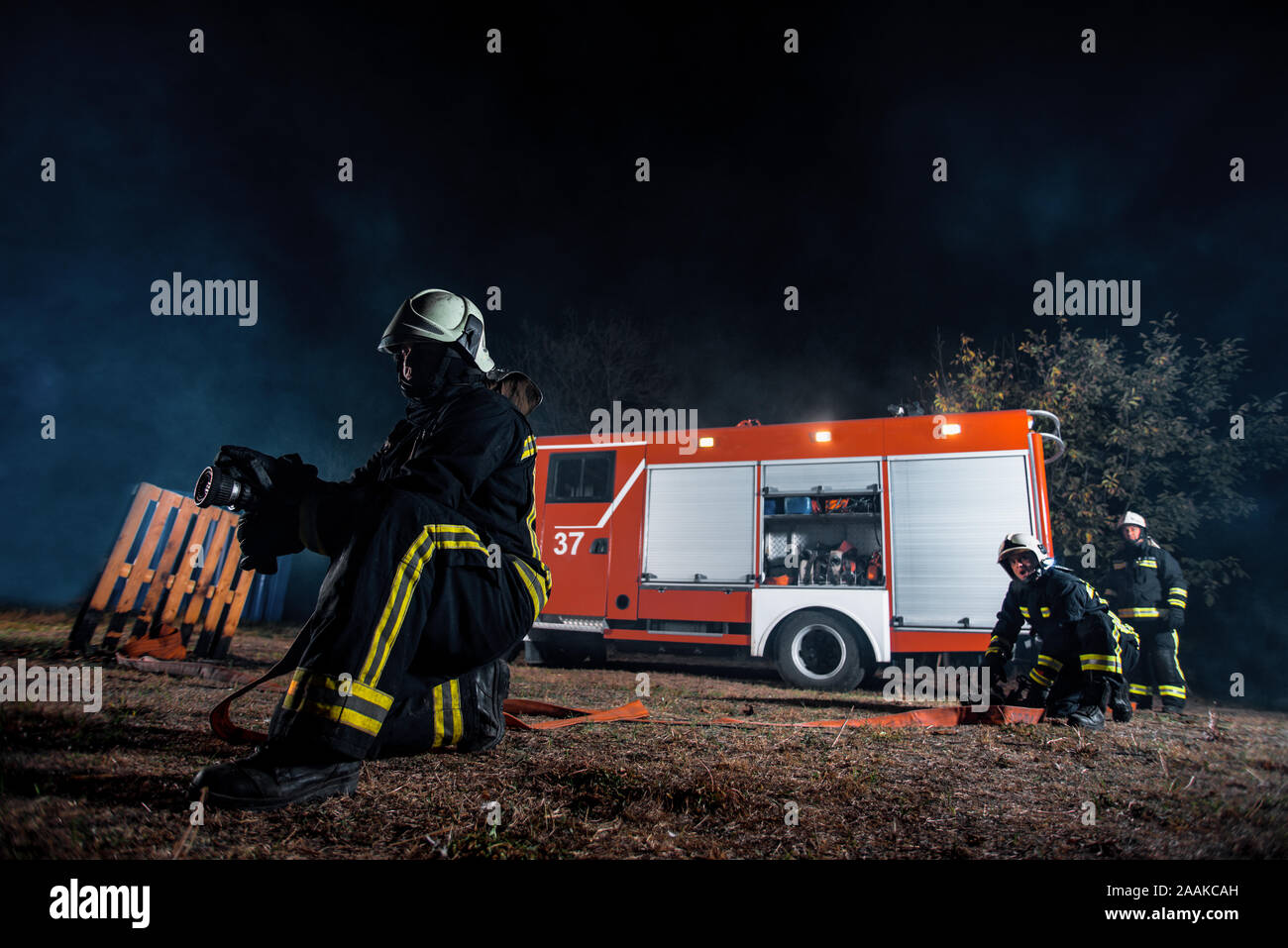 Firemen getting ready during a firefighting intervention Stock Photo ...