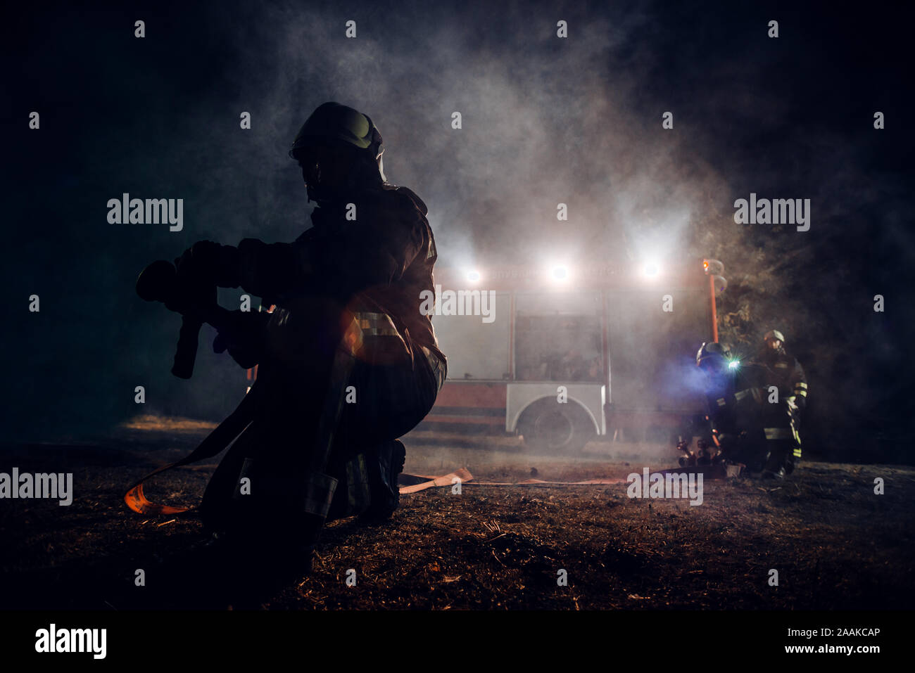Fire brigade during operation in the field at night time Stock Photo ...