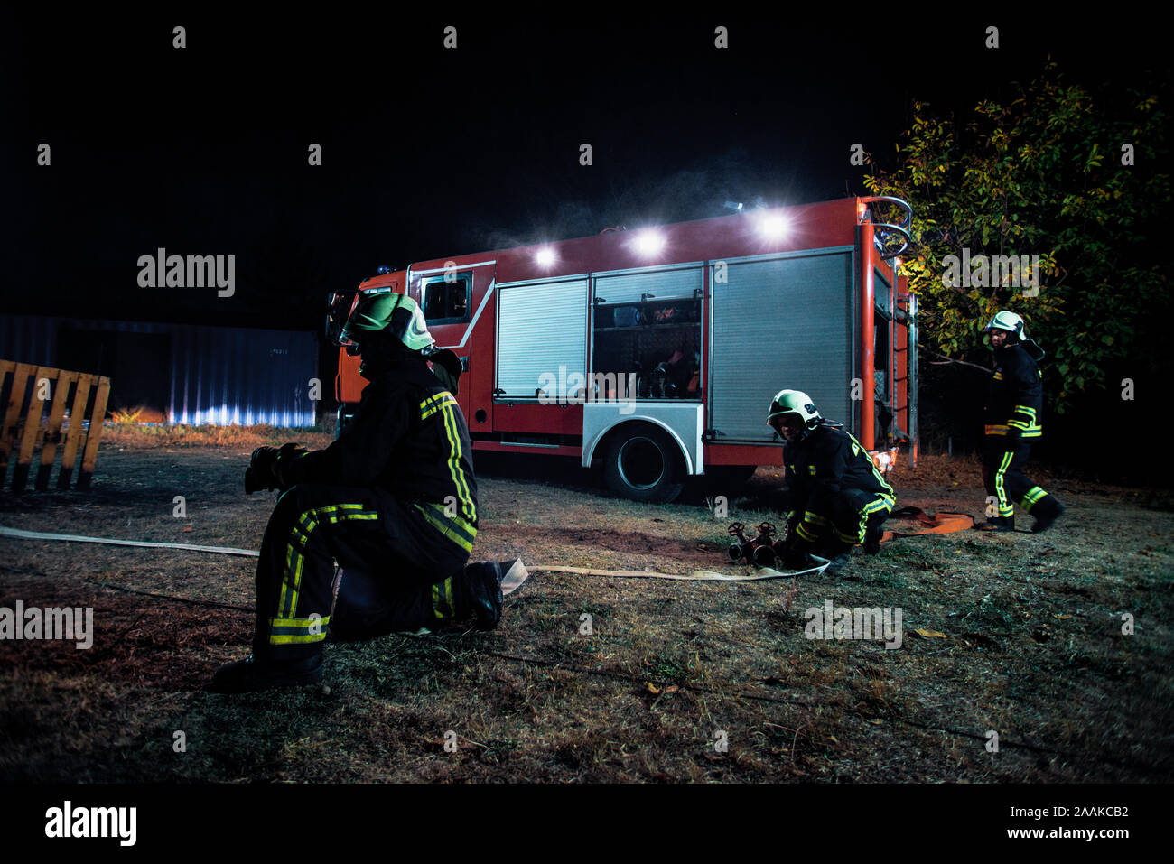 Fire brigade during operation in the field at night time Stock Photo ...