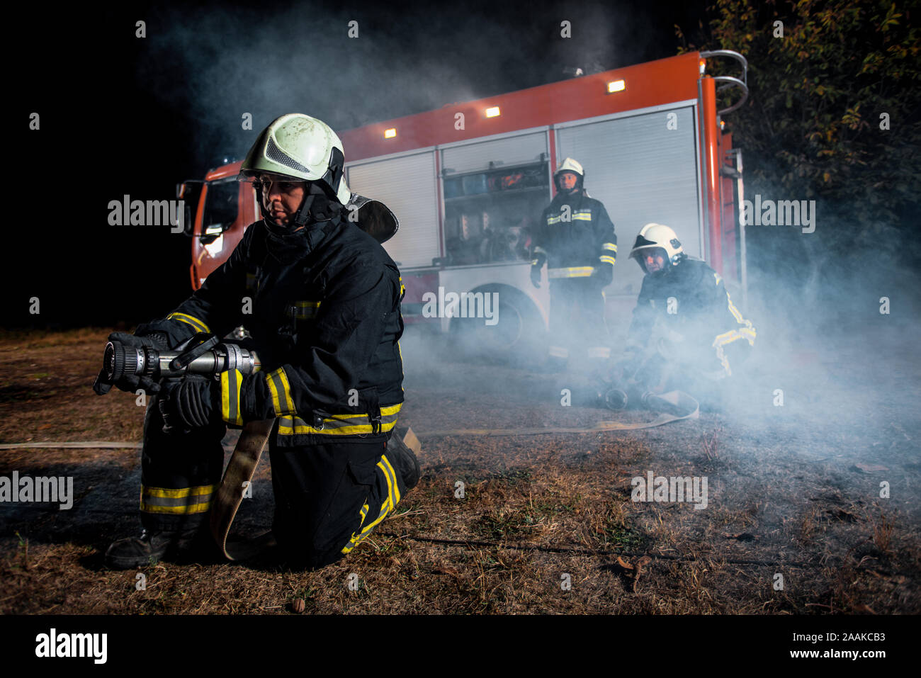 Fire brigade during operation in the field at night time Stock Photo ...