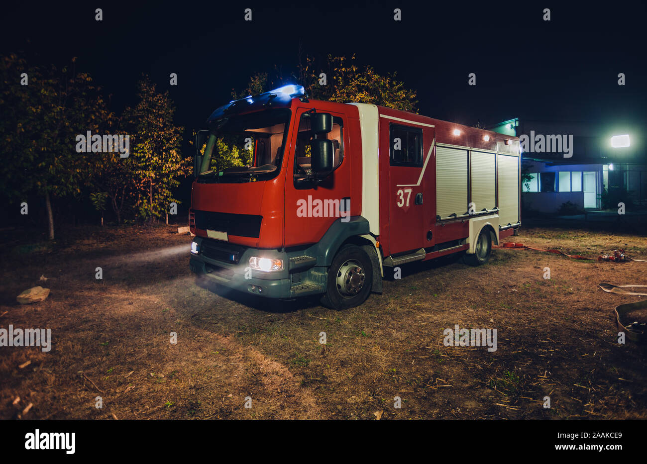 Firefighter pumper truck operating in the field Stock Photo - Alamy