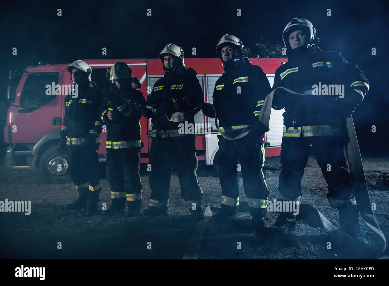 Fire brigade fighting a forest fire with various tools for eliminating ...