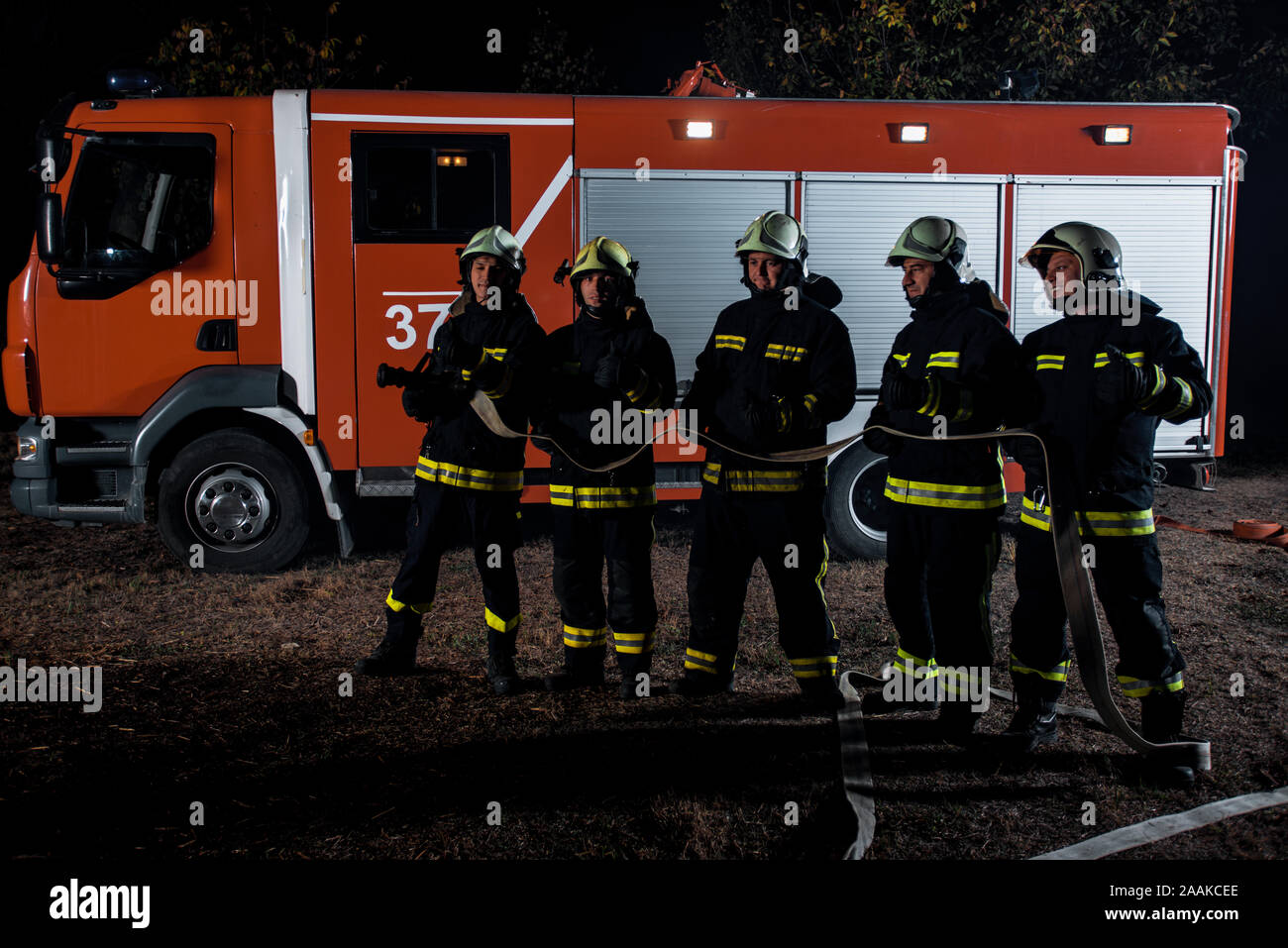 Firemen getting ready during a firefighting intervention Stock Photo ...